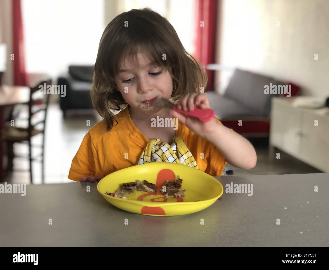 Children eating by herself at home Stock Photo - Alamy