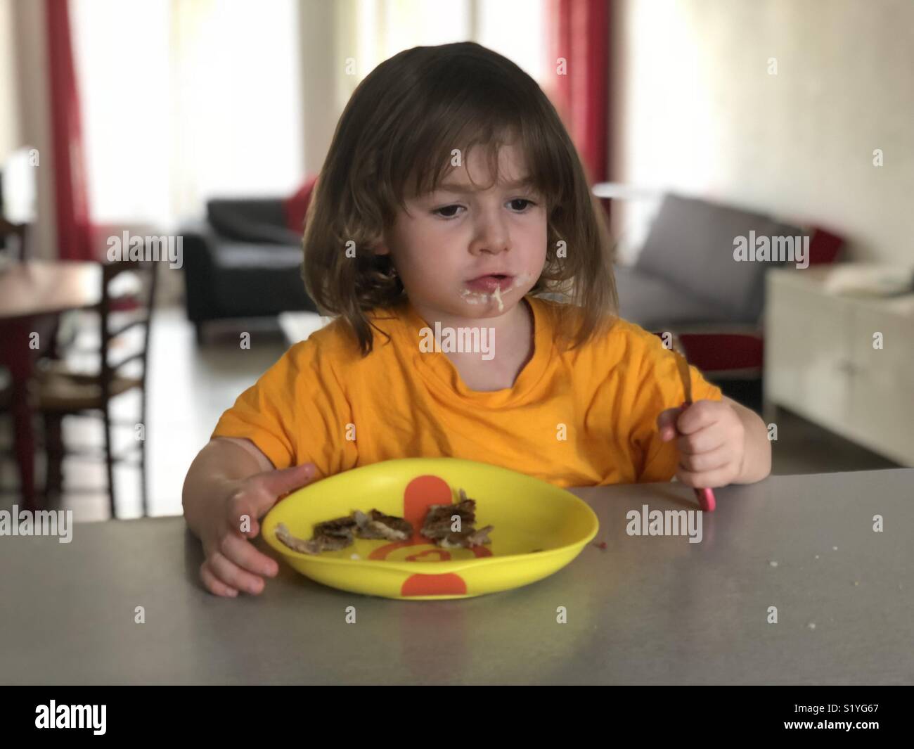 Toddler eating at home Stock Photo - Alamy