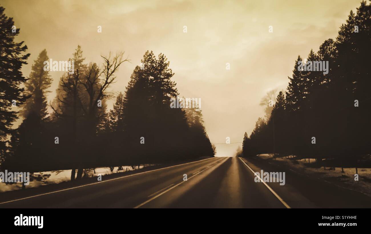 Empty highway leading away into the distance. Dark vintage edit. Space ...