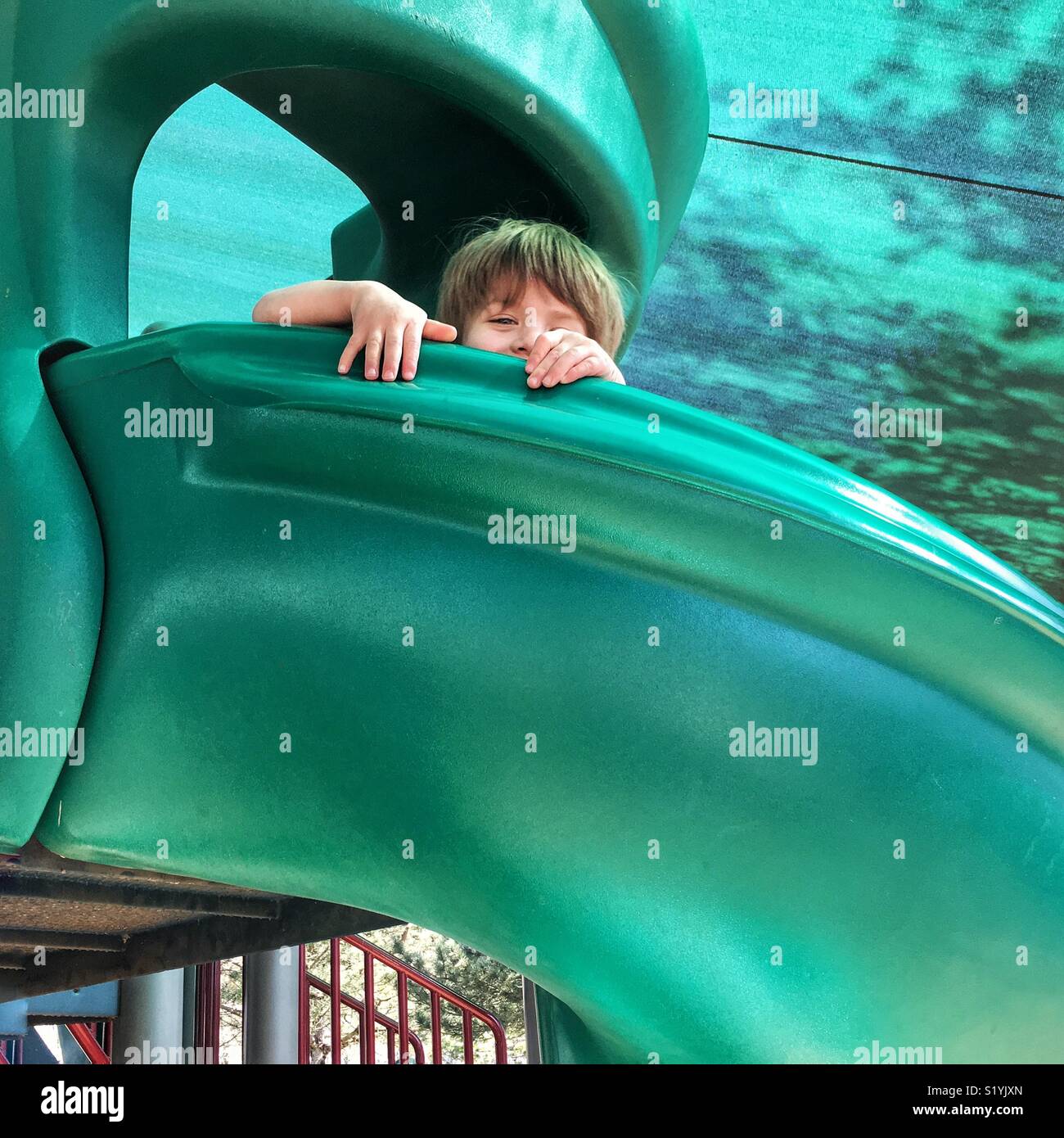 Boy on slide hi-res stock photography and images - Alamy
