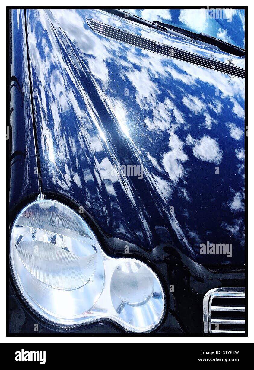 Reflections of clouds on the hood of a blue car Stock Photo - Alamy