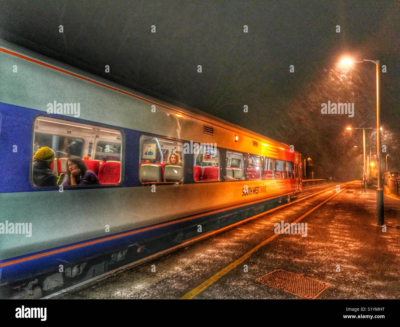 South West Train at Sherborne Station at dawn, with commuters on the ...
