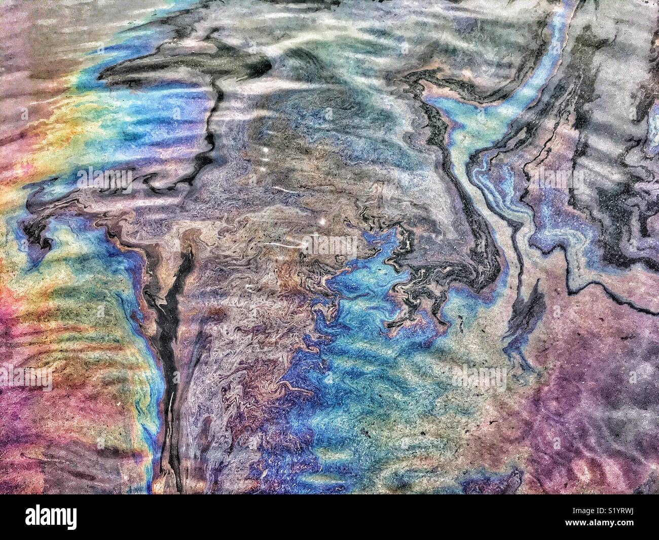 Rainbow colors of gasoline. Water pollution concept Stock Photo - Alamy