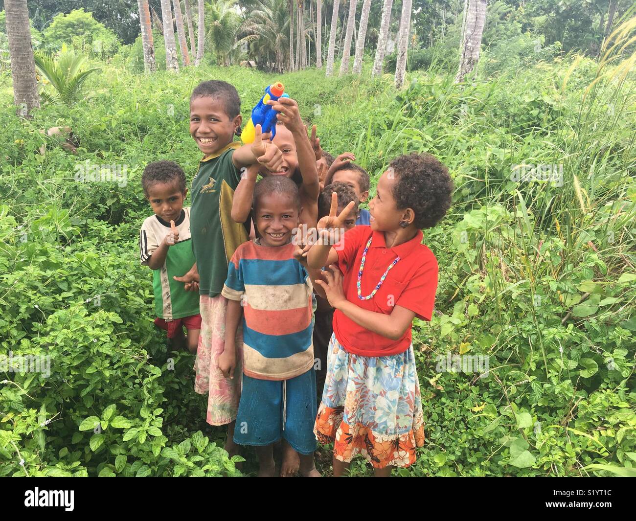 Kids following us to the bush toilet in PNG Stock Photo - Alamy