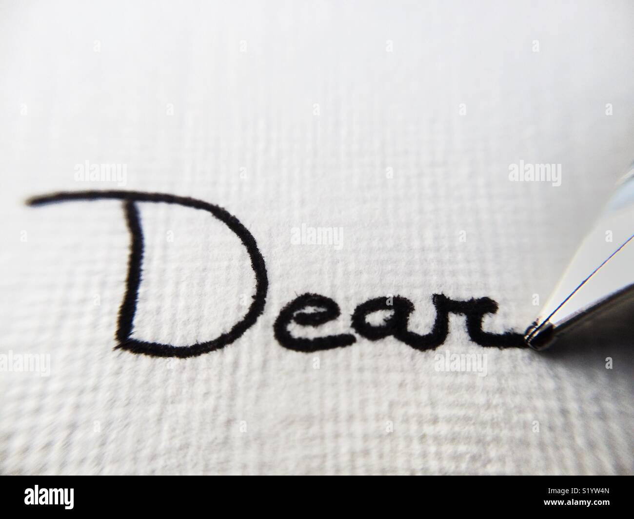 Dear written on paper Stock Photo - Alamy