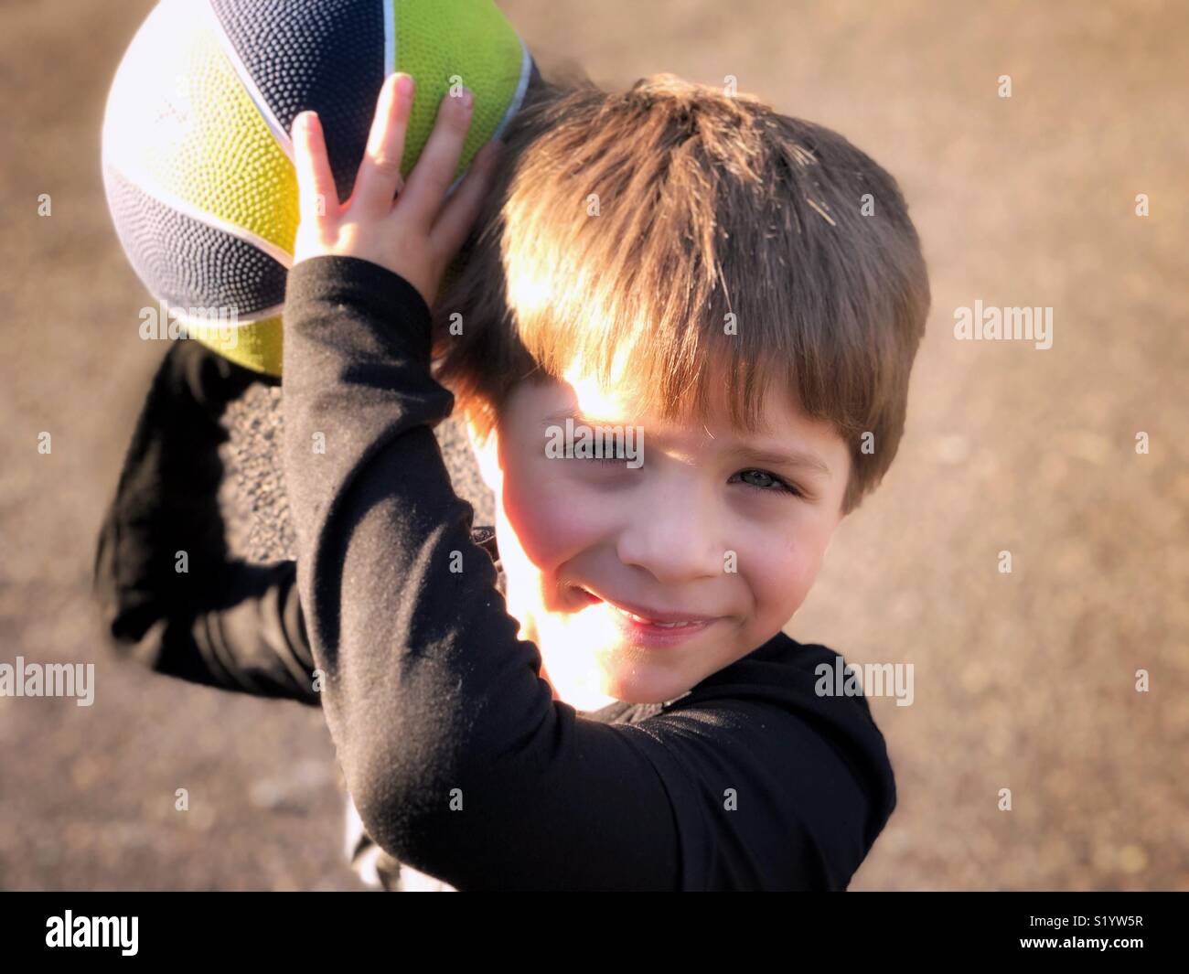 Boy holding ball hi-res stock photography and images - Alamy