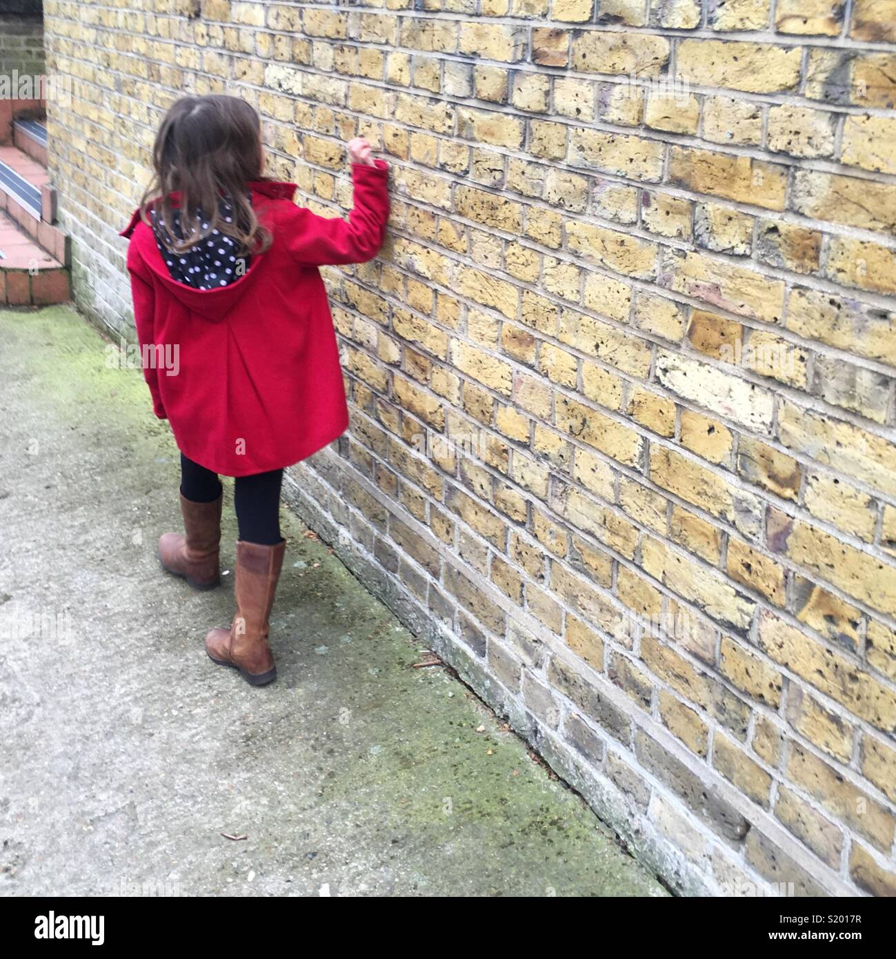 Girl walking along wall hi-res stock photography and images - Alamy