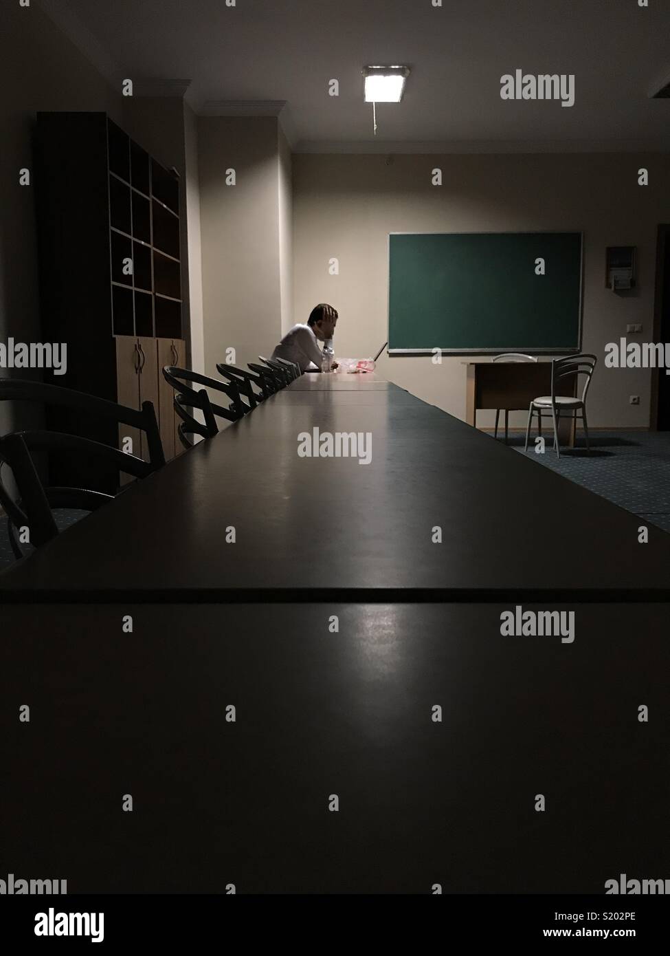 University student alone at desk hi-res stock photography and images ...