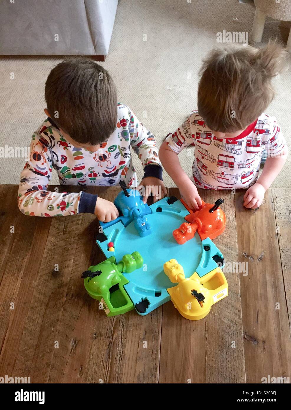 Boys playing hippo game Stock Photo - Alamy