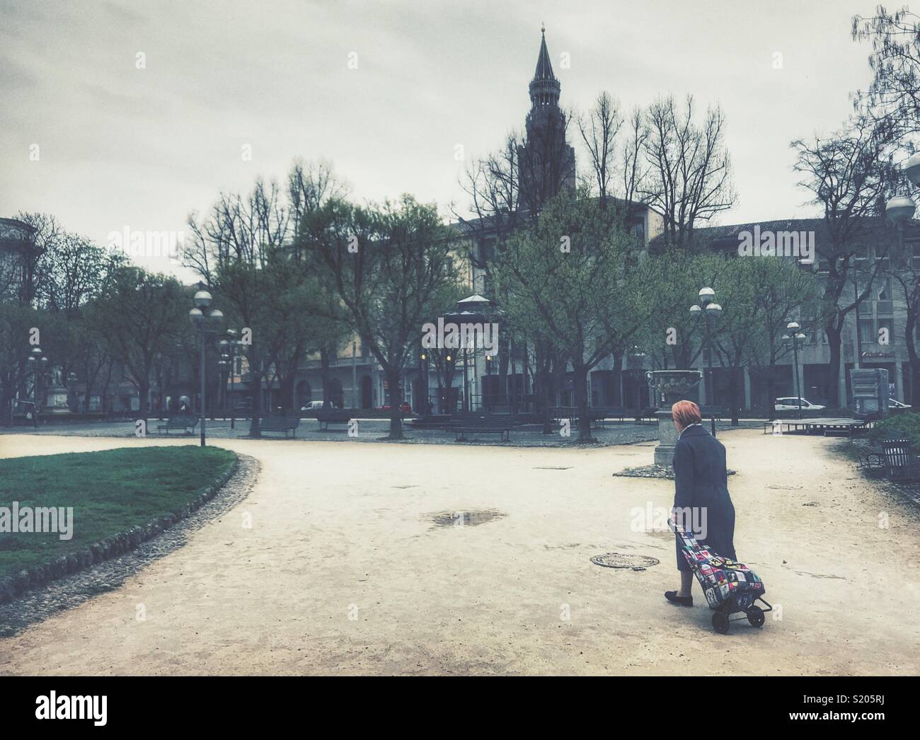 Dull spring day in the park with pnly one woman around Stock Photo - Alamy