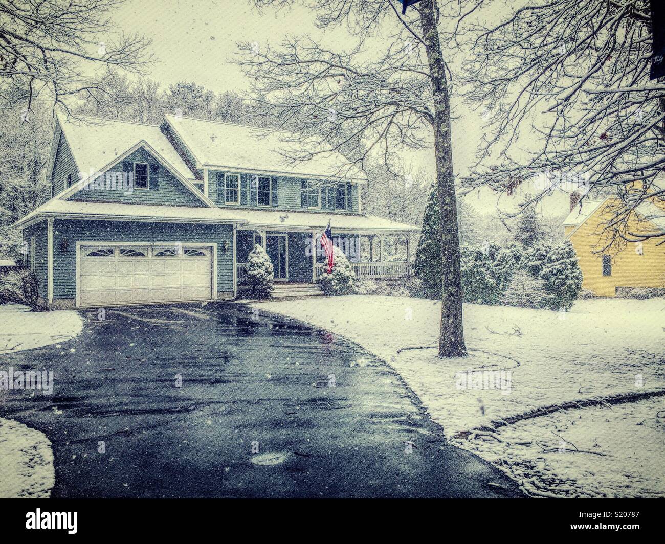 Scenic winter scene of suburban new England luxury home, driveway and ...