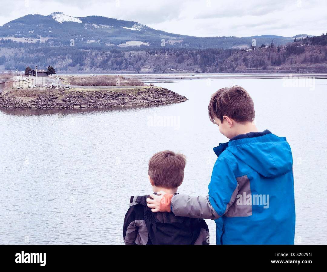 Brothers in front of river Stock Photo - Alamy