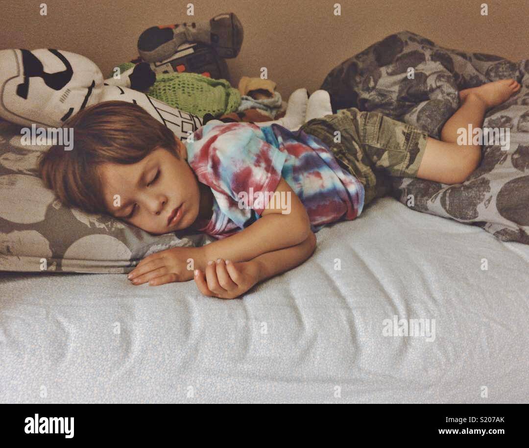 Little boy napping in bed Stock Photo - Alamy