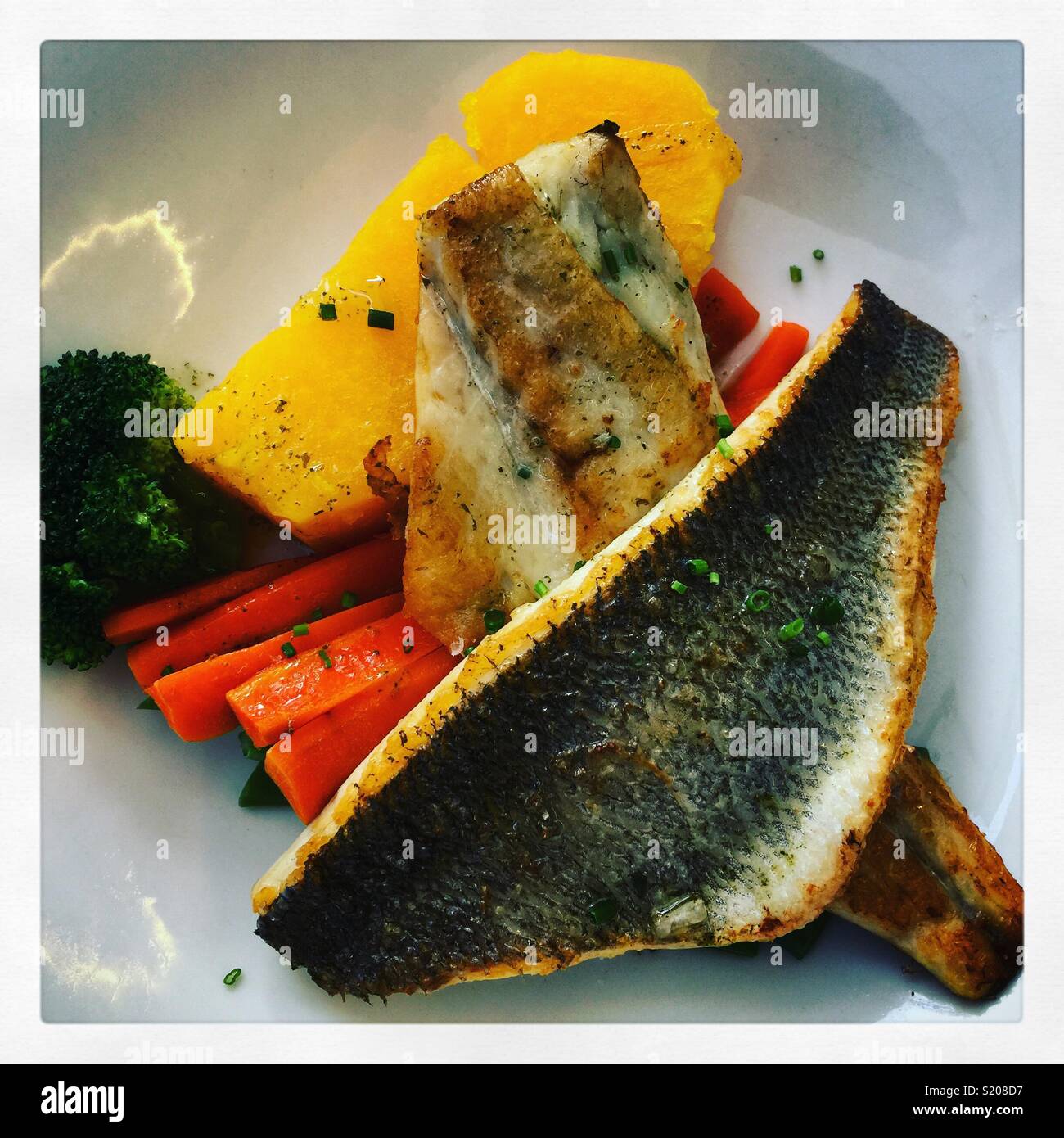 Sea bass and vegetables Stock Photo - Alamy