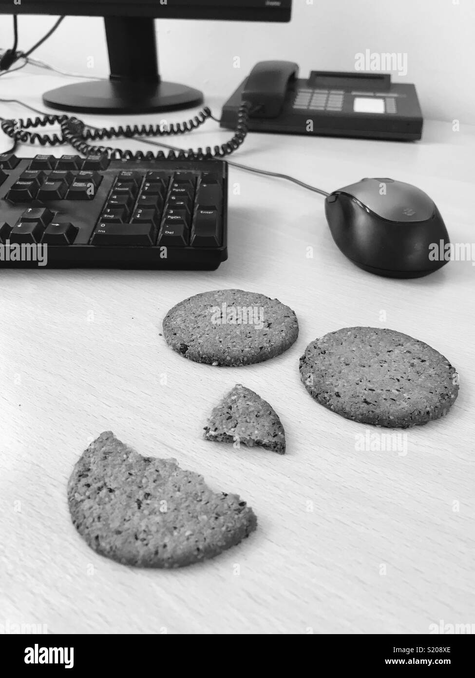 Black and white biscuits on an office desk Stock Photo - Alamy
