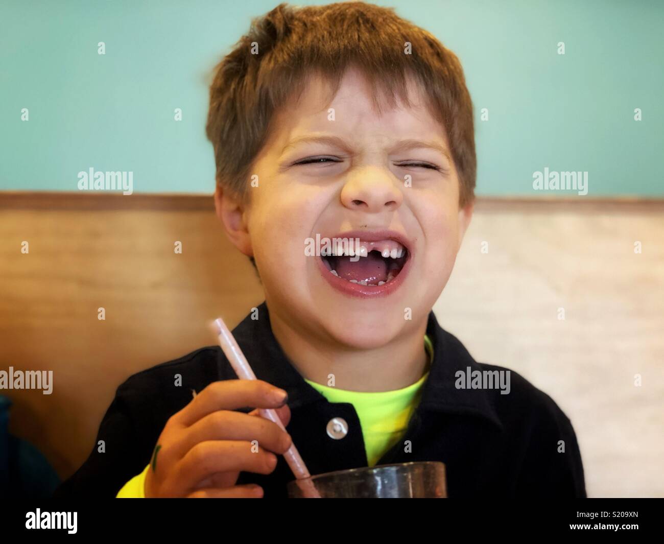 Boy with missing front tooth being goofy Stock Photo - Alamy