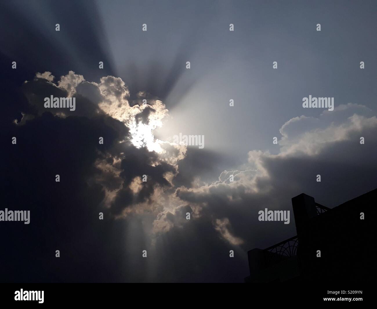 Sun coming out of the clouds Stock Photo - Alamy