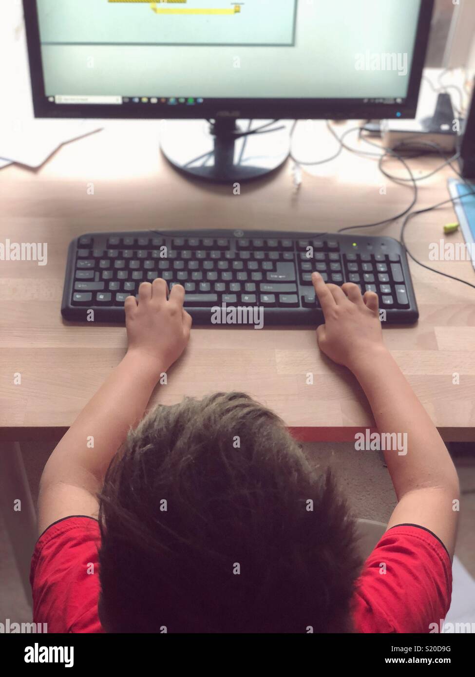 Boy in front of computer hi-res stock photography and images - Alamy