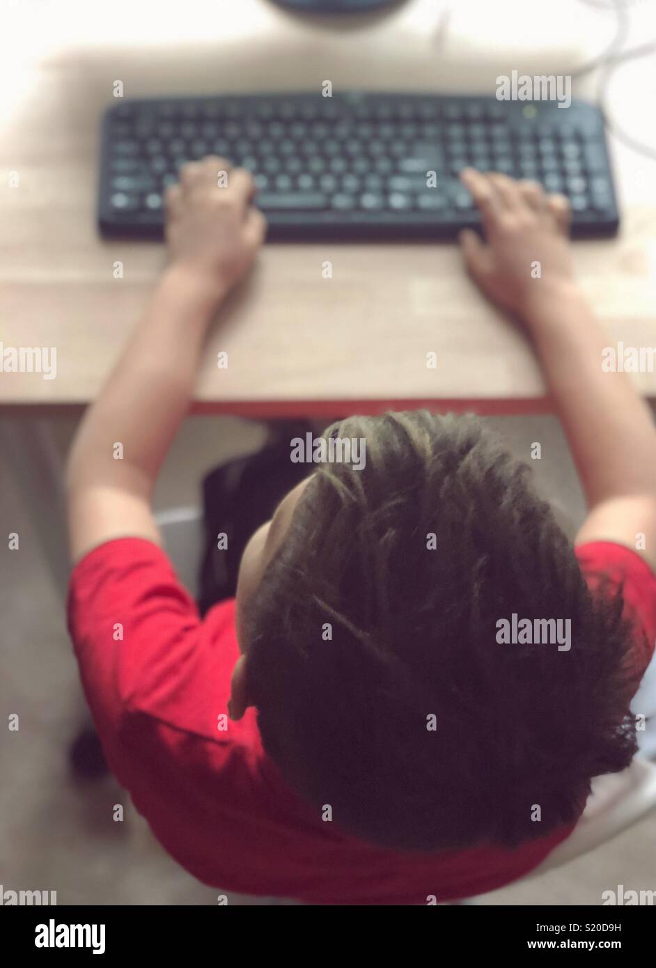 Boy in front of computer Stock Photo - Alamy