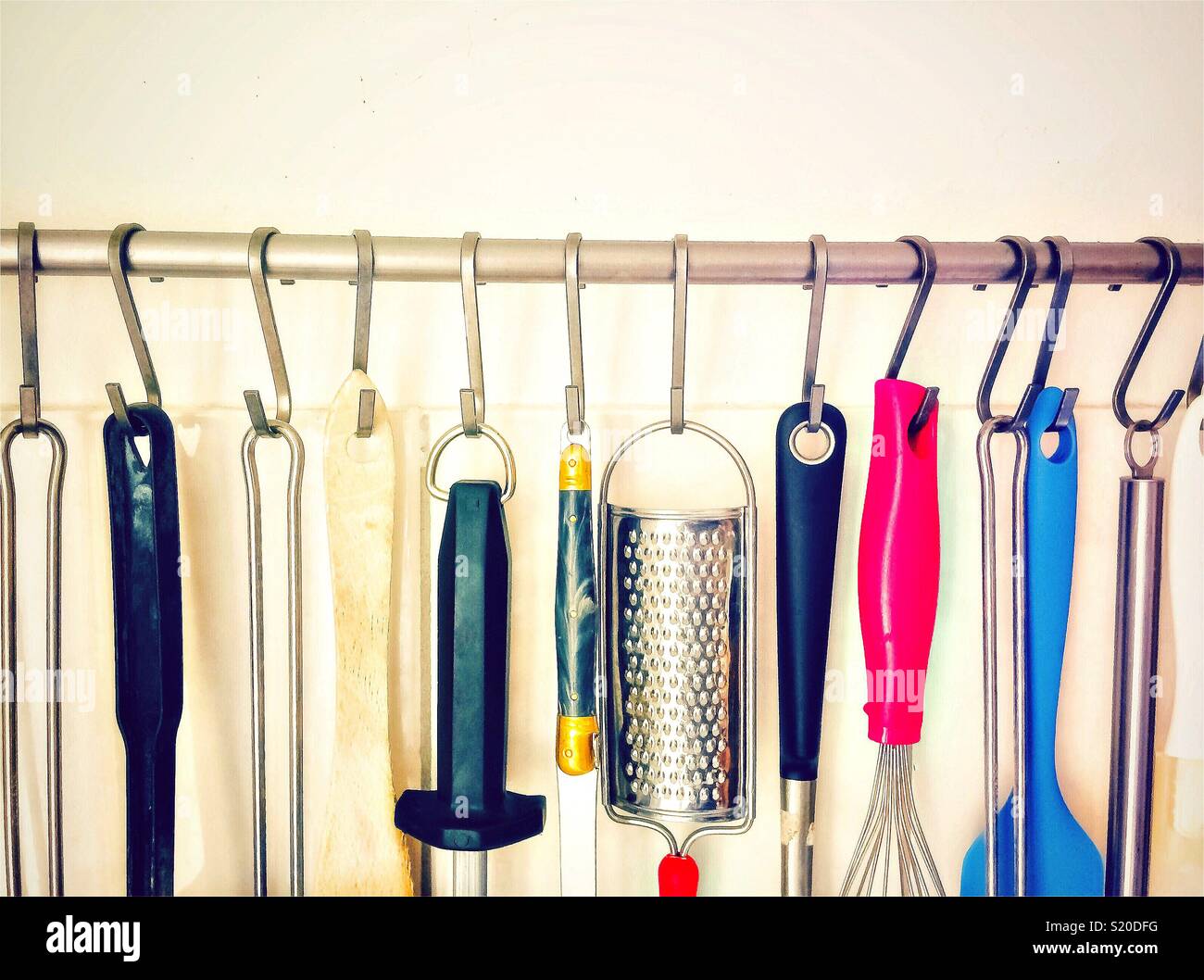 Kitchenware hanging from the wall in the kitchen Stock Photo - Alamy