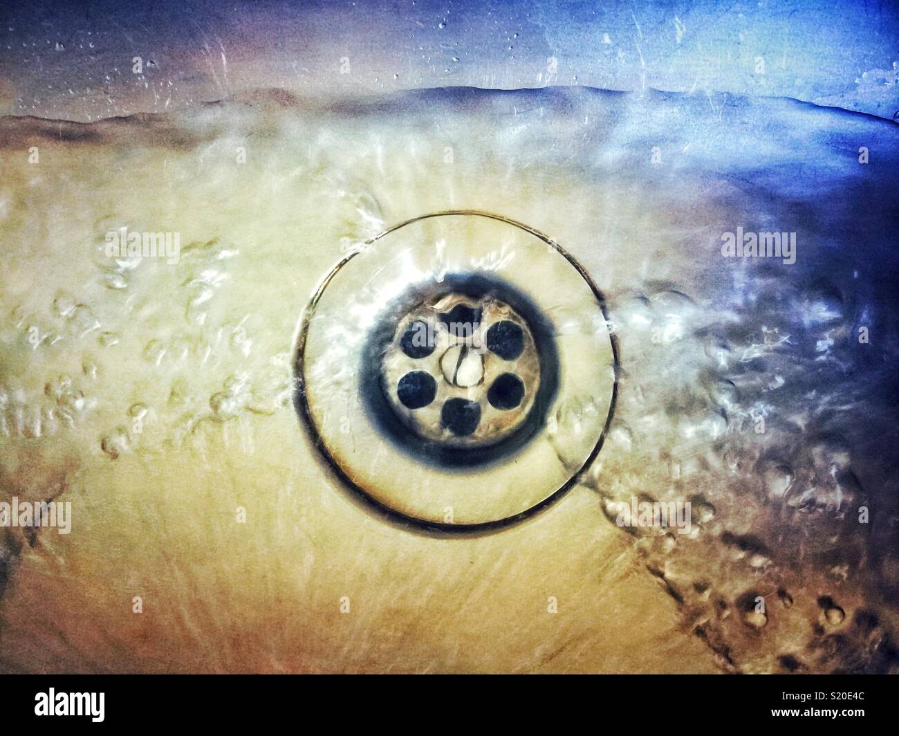Water swirling down a drain sink Stock Photo - Alamy