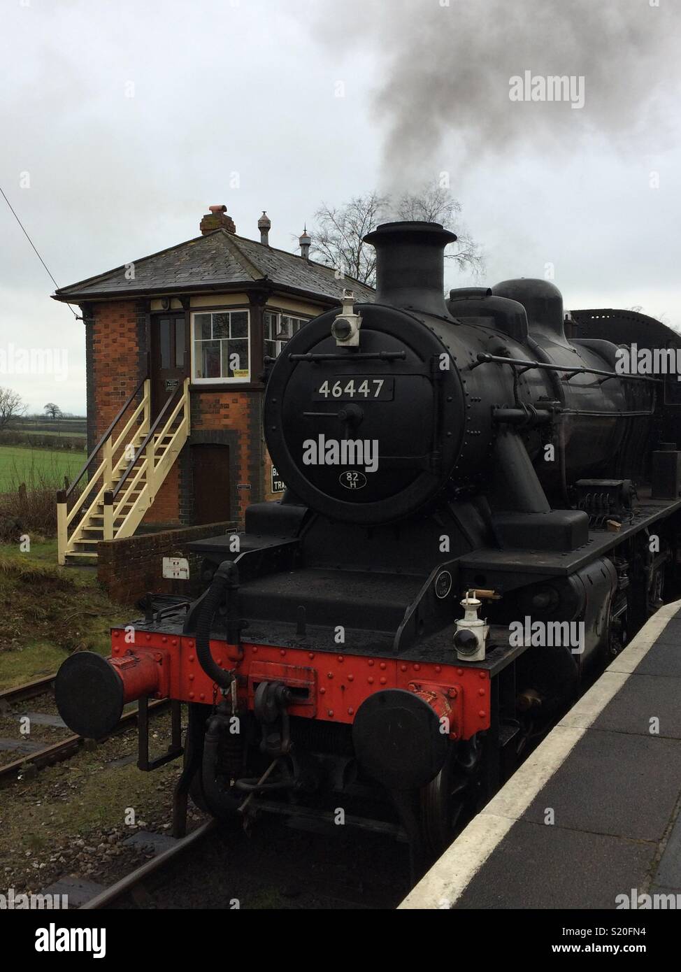 Steam engine at platform with signal box Stock Photo - Alamy