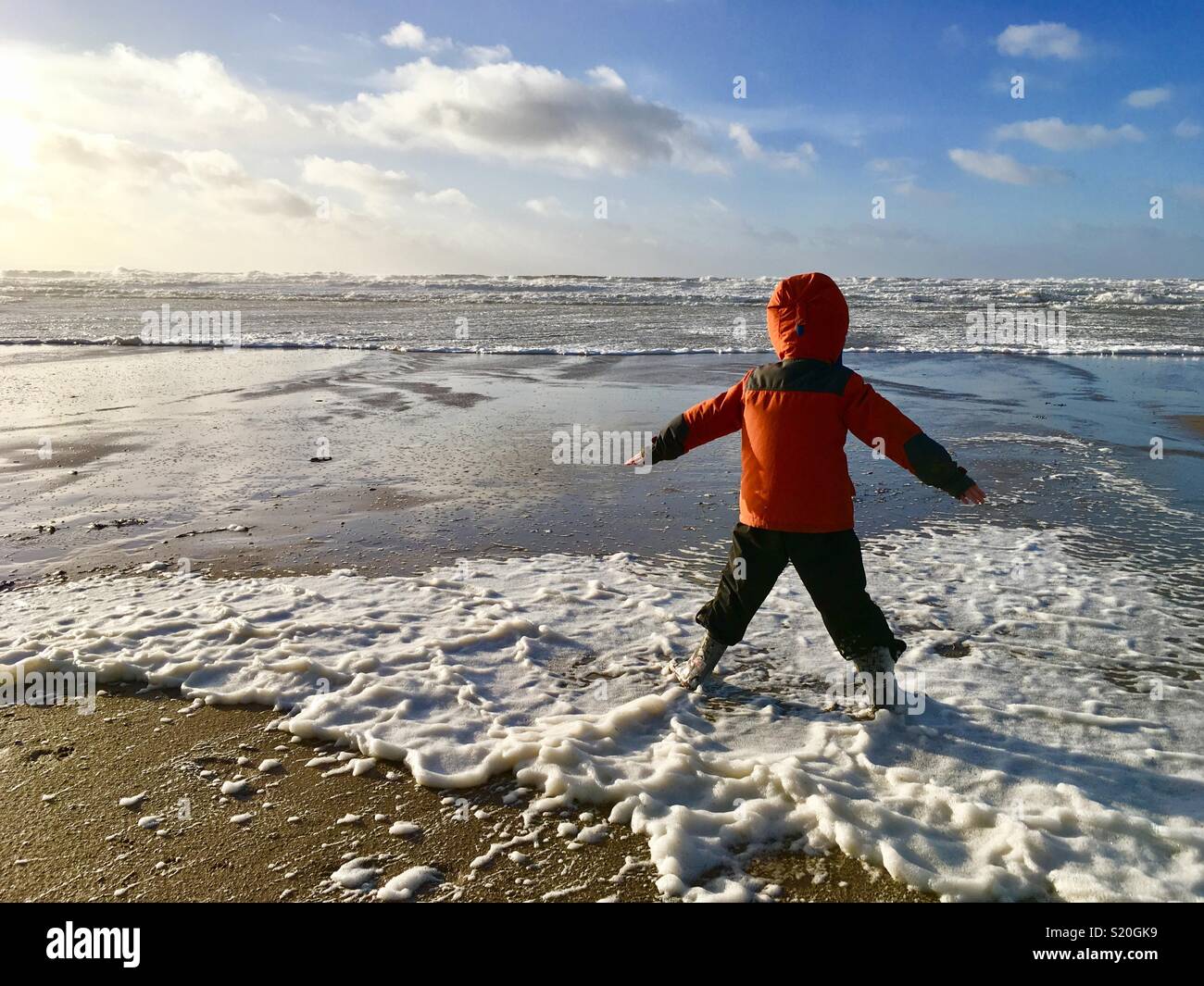 Child on a windy Croyde Beach in North Devon Stock Photo - Alamy
