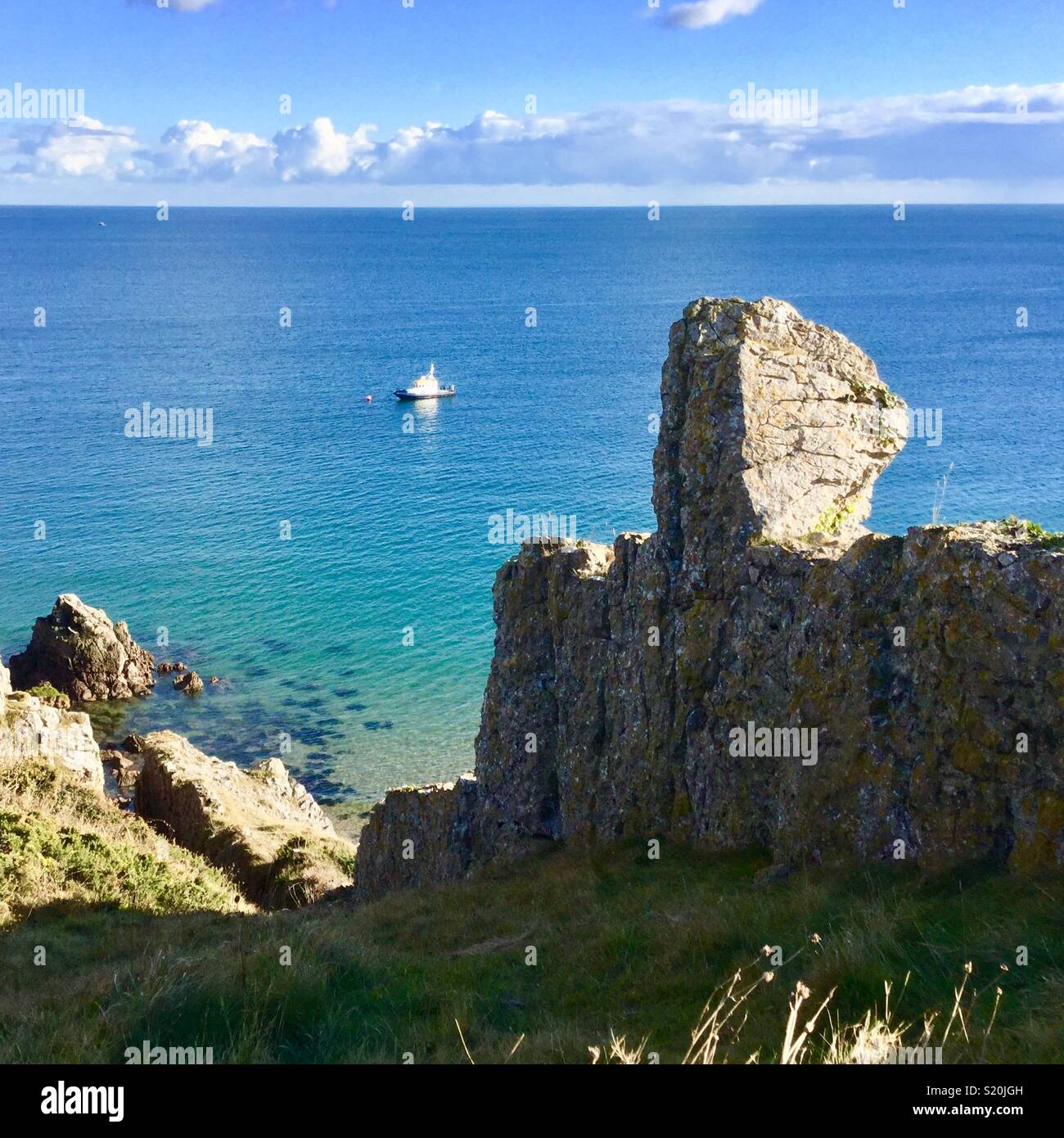 Boat at Sea off the Welsh Coast at Barafundle Stock Photo - Alamy