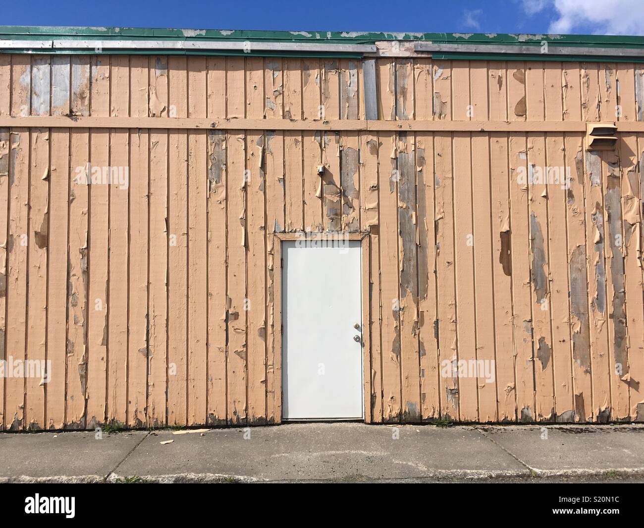 Paint flaking off wooden building Stock Photo - Alamy