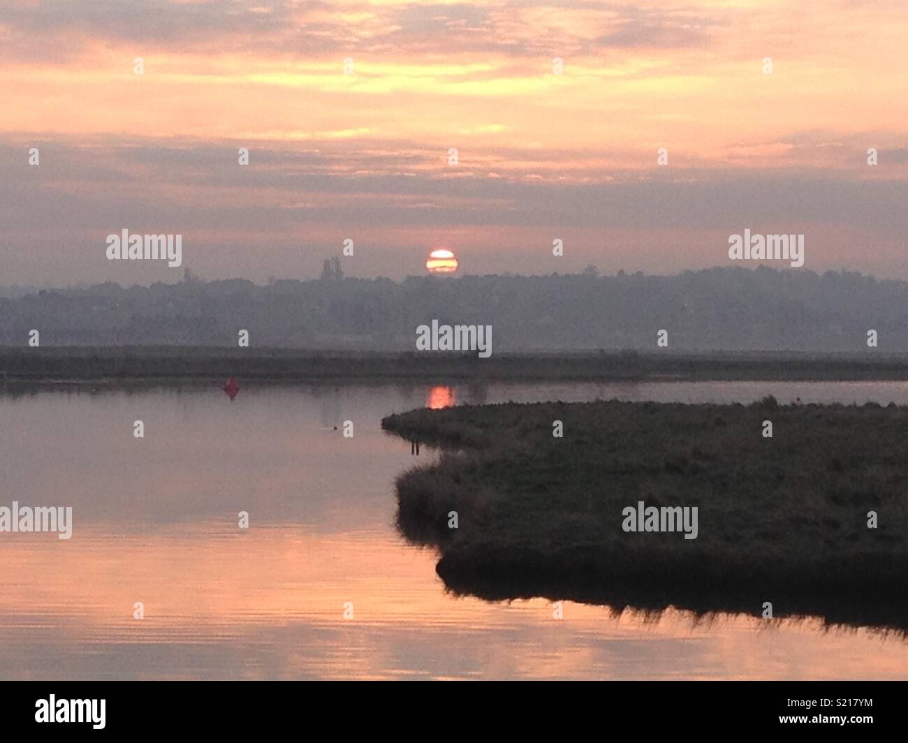 Sunrise over water Stock Photo - Alamy