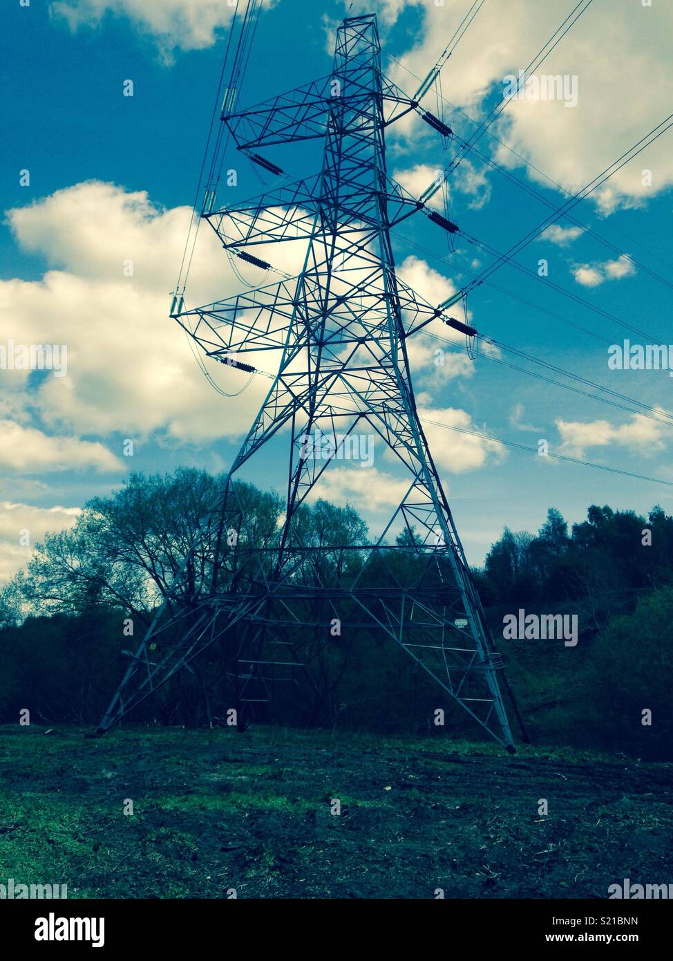 Pylon in Reddish Vale Country Park, shown against a blue sky with ...