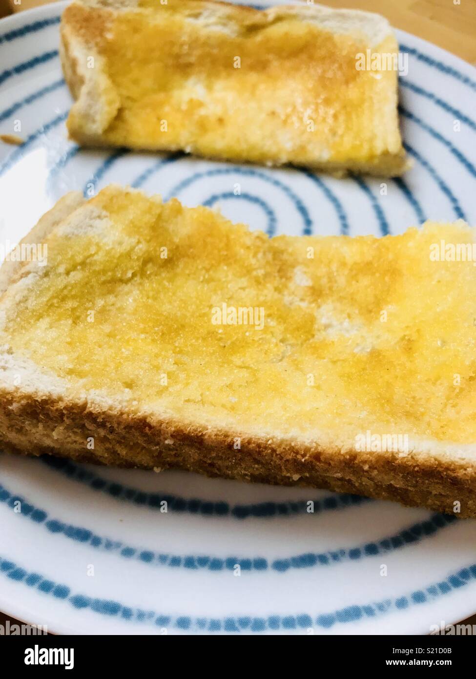 Buttered white toast Stock Photo - Alamy
