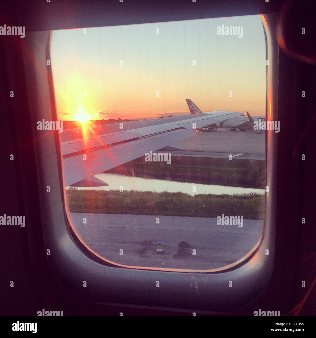 Sunrise from an airplane window on take off Stock Photo - Alamy