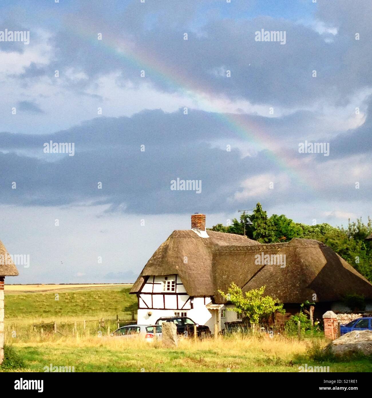 Rainbow over cottage Stock Photo - Alamy