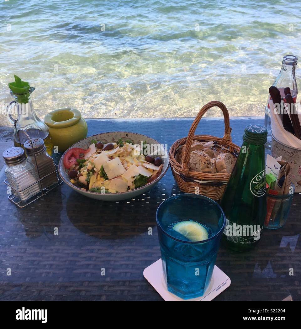 Greek Lunch by the ocean Stock Photo - Alamy