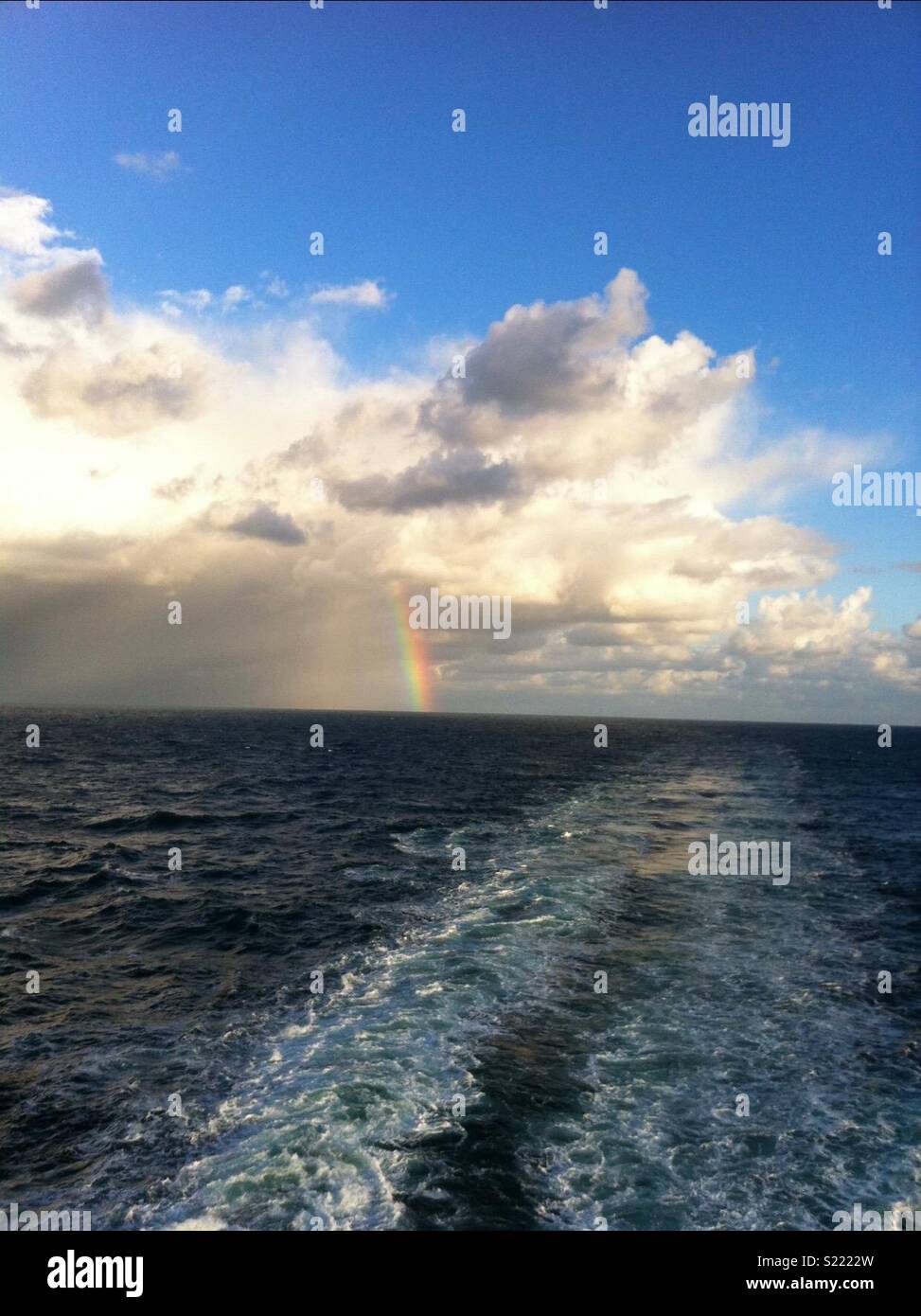 Rainbow at Sea Stock Photo - Alamy