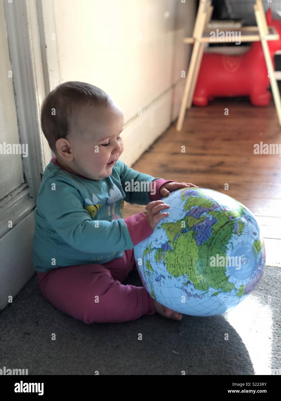 Baby holding globe Stock Photo - Alamy