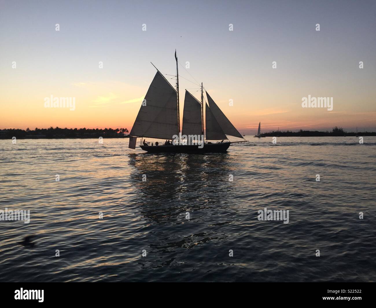 Key west sunset with sail boat Stock Photo - Alamy