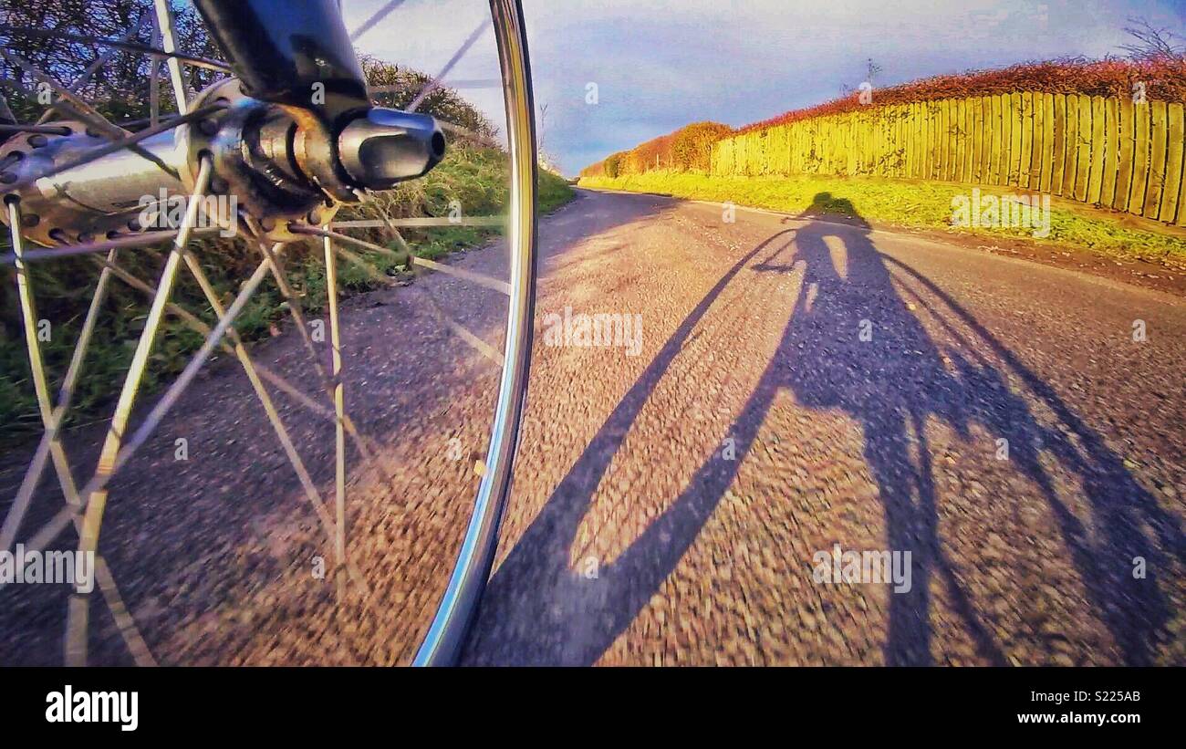 Bike wheel and cyclists’ shadow Stock Photo - Alamy