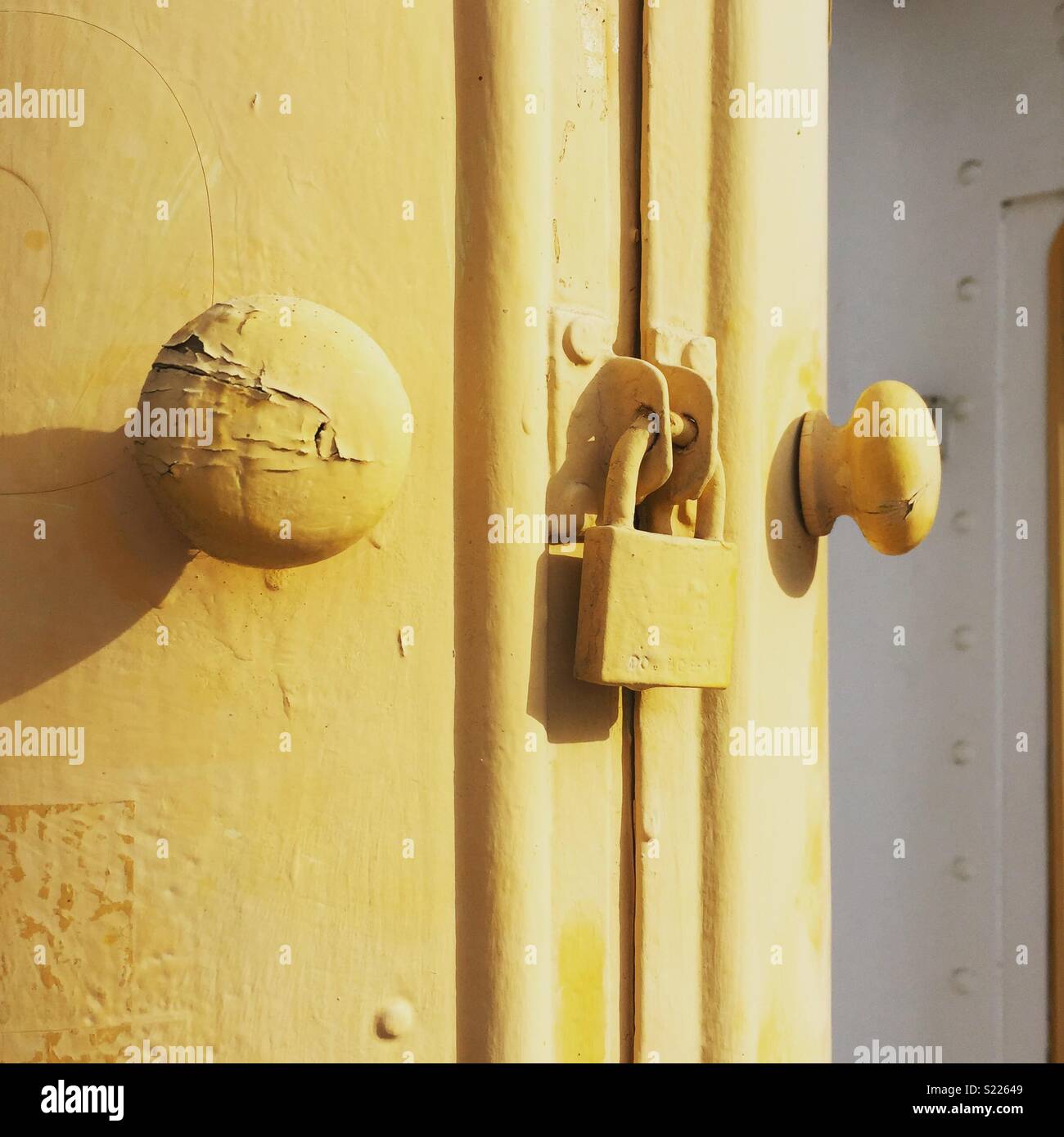 Yellow door and lock Stock Photo - Alamy