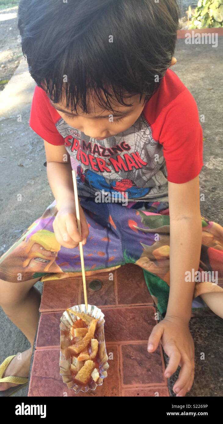 Enjoying his tempura..street foods Stock Photo - Alamy