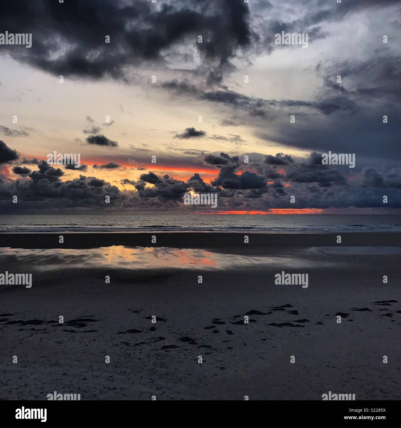 Orange fluorescent sunset at the beach Stock Photo - Alamy