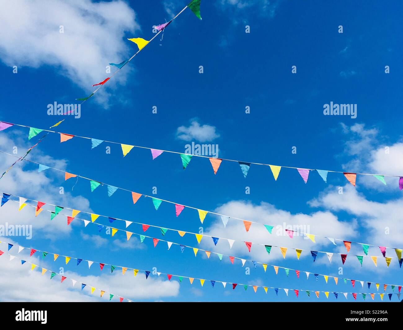 Blue sky with colourful bunting Stock Photo - Alamy