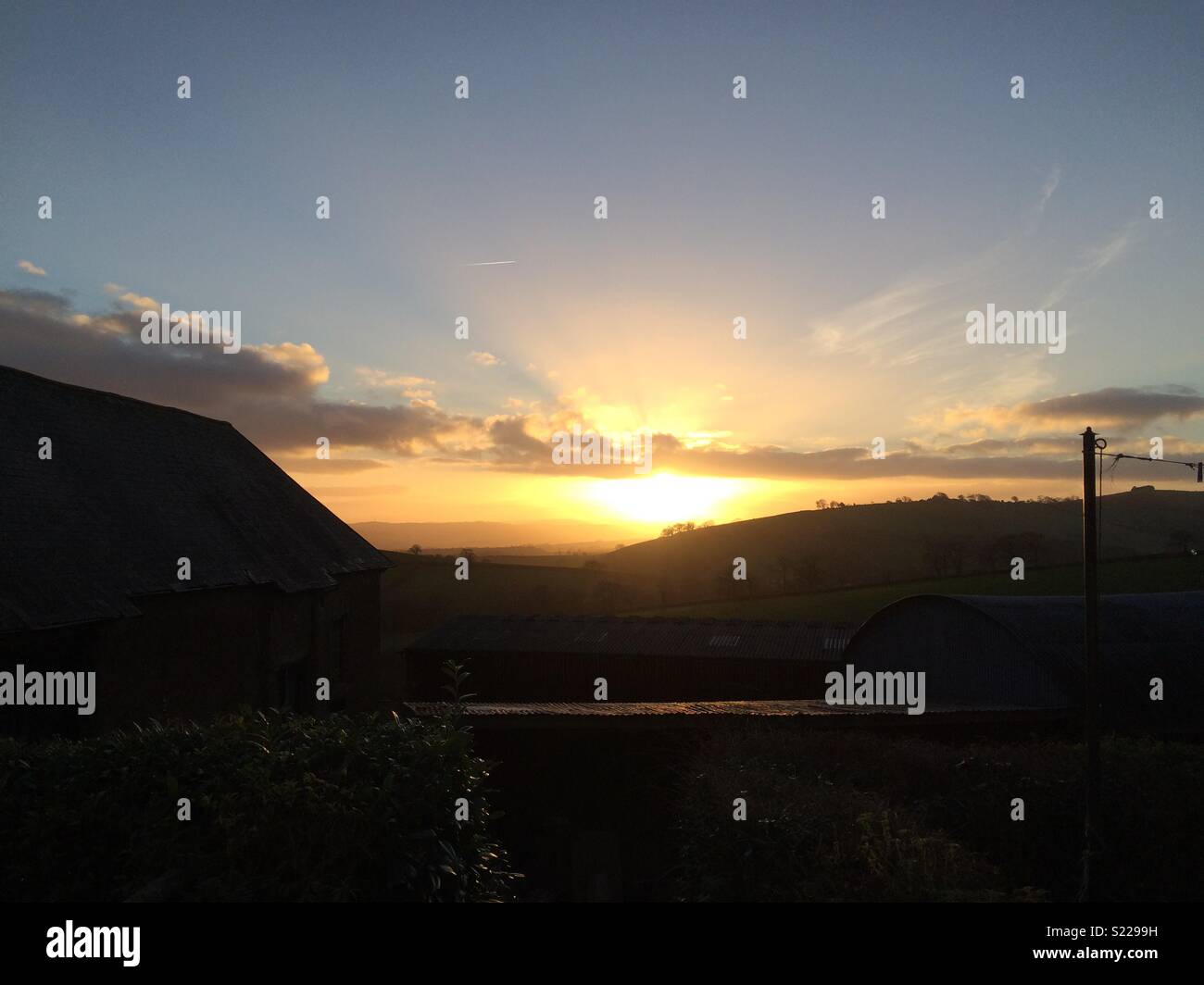 Sunset over farm yard Stock Photo - Alamy