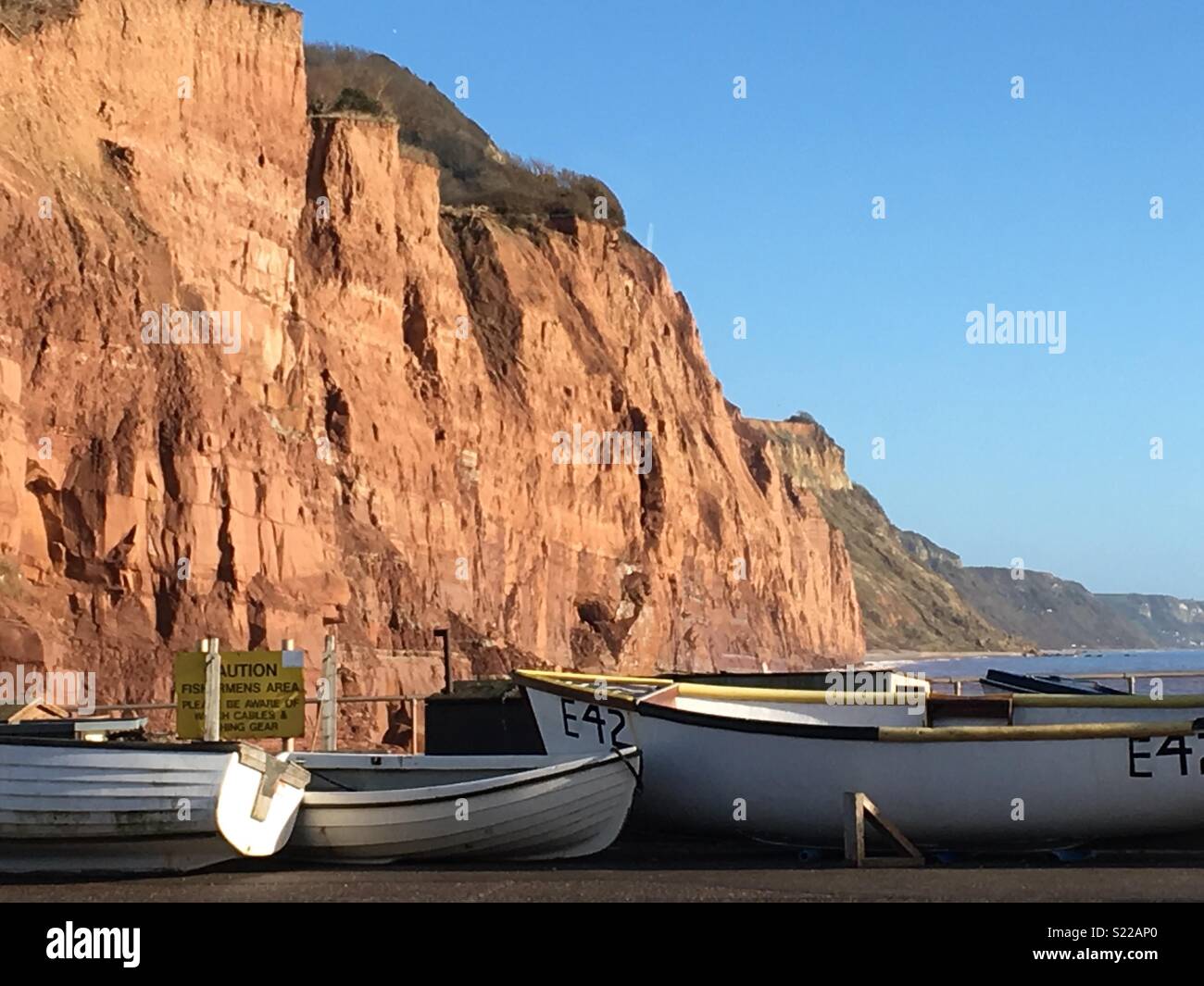 Boats in front of crumbing cliff Sidmouth Beach Stock Photo - Alamy