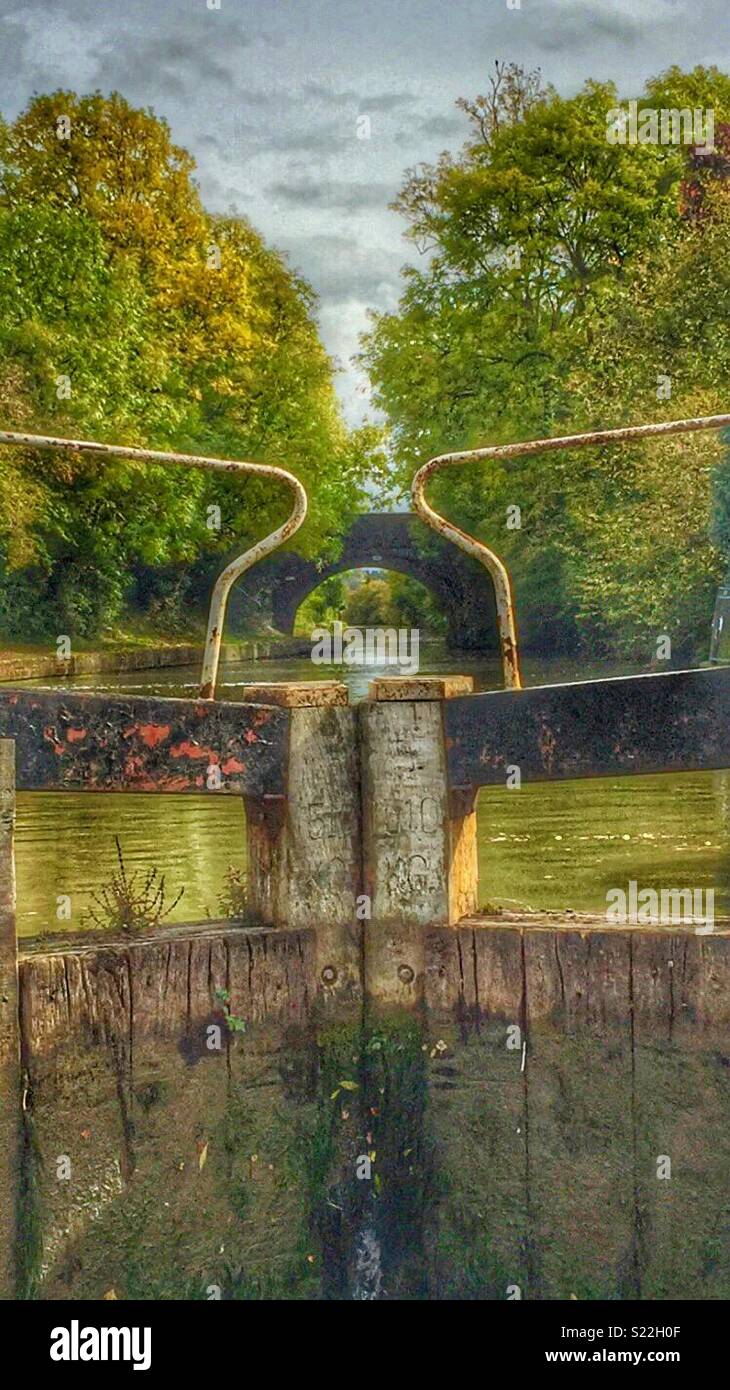 Canal bridge through lock gates Stock Photo - Alamy