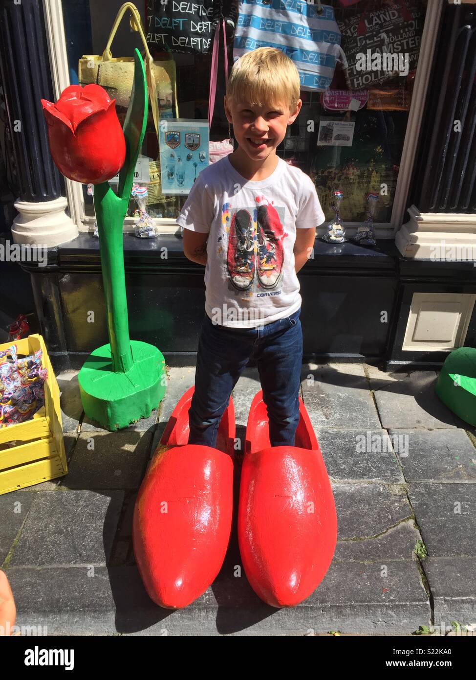 Child standing in giant clogs in Amsterdam on a sunny summers day Stock ...