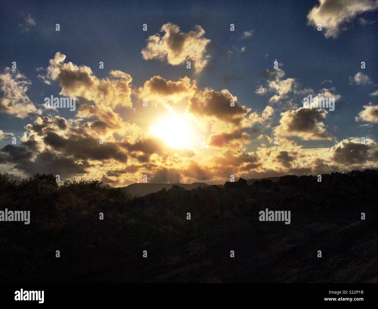 Sun breaking through clouds Stock Photo - Alamy