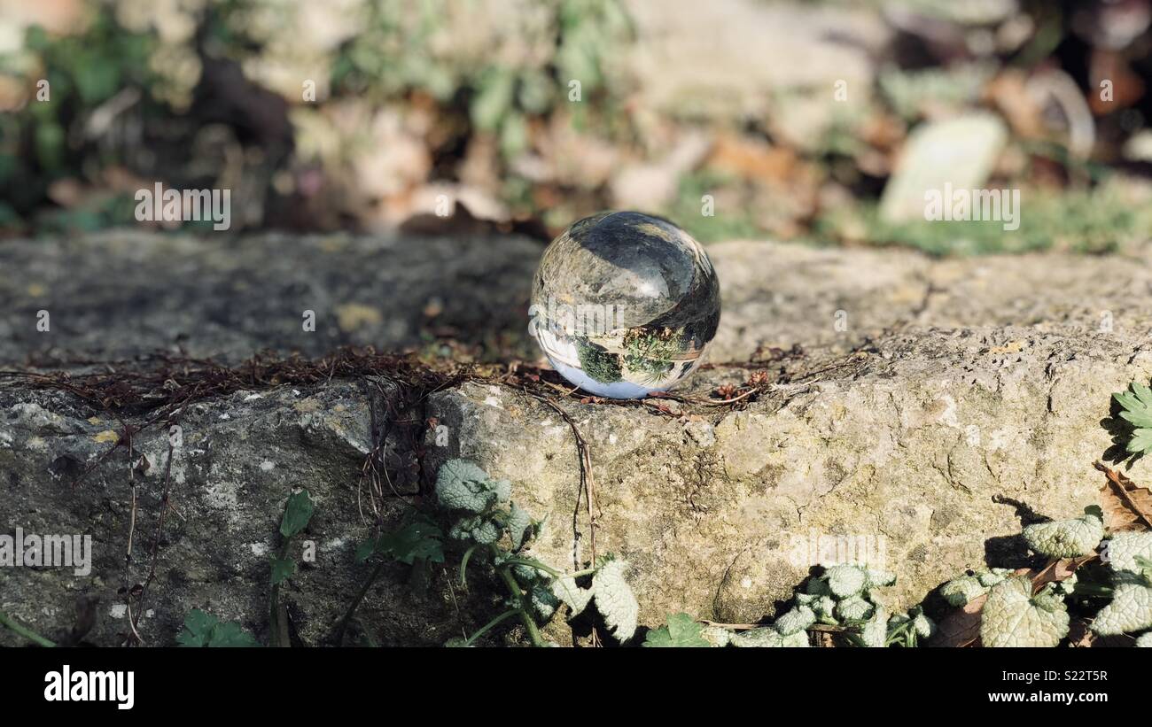 Glass ball on stone Stock Photo - Alamy