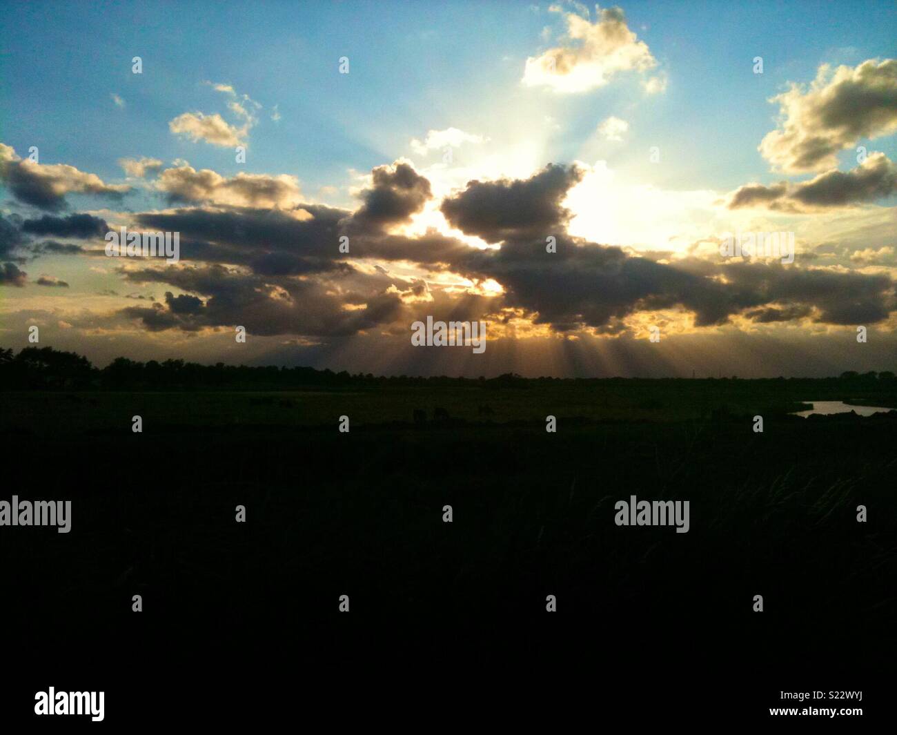 Sun rays passing through clouds hi-res stock photography and images - Alamy